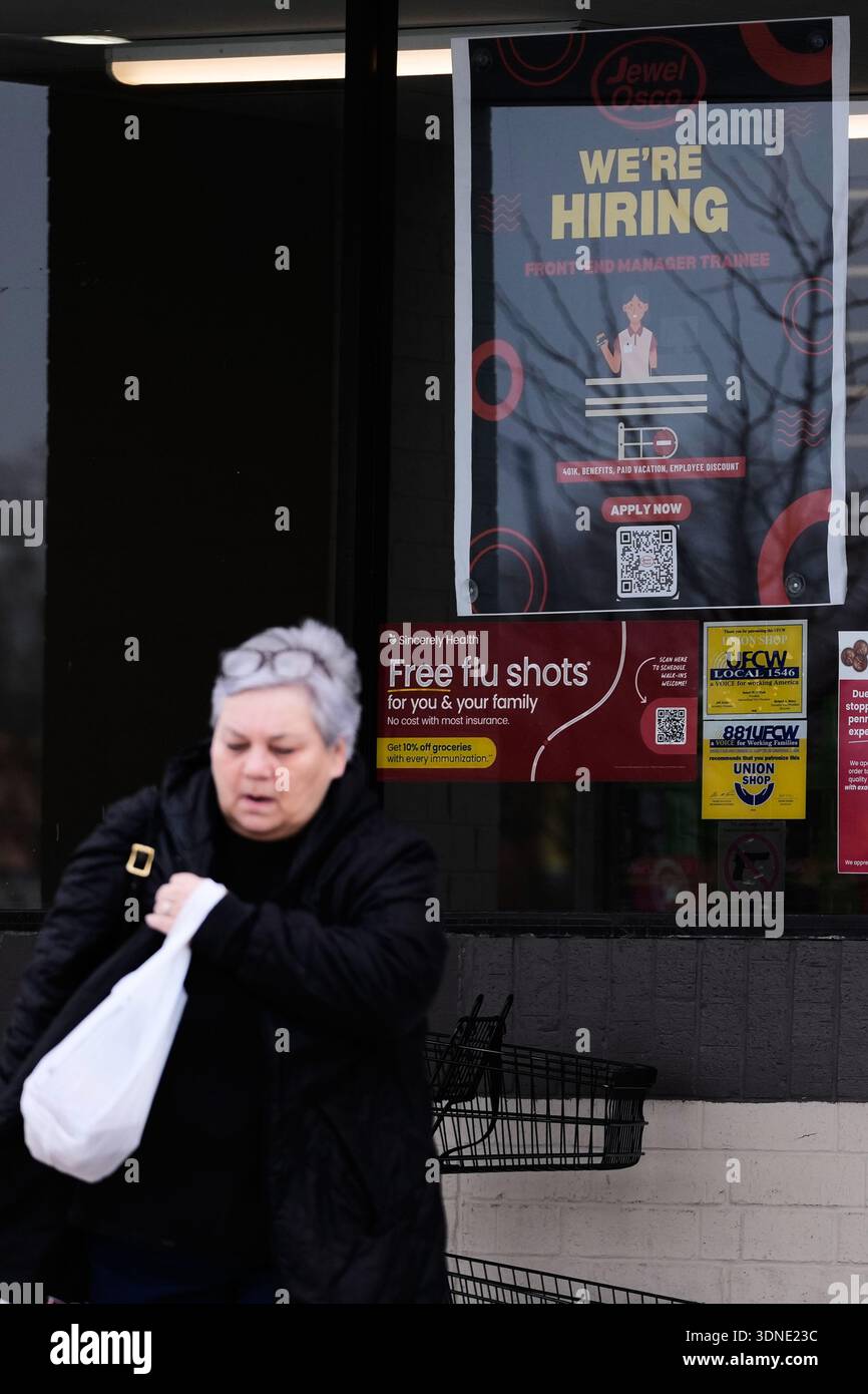 Hiring sign is displayed at a grocery store in Schaumburg, Ill., Monday ...