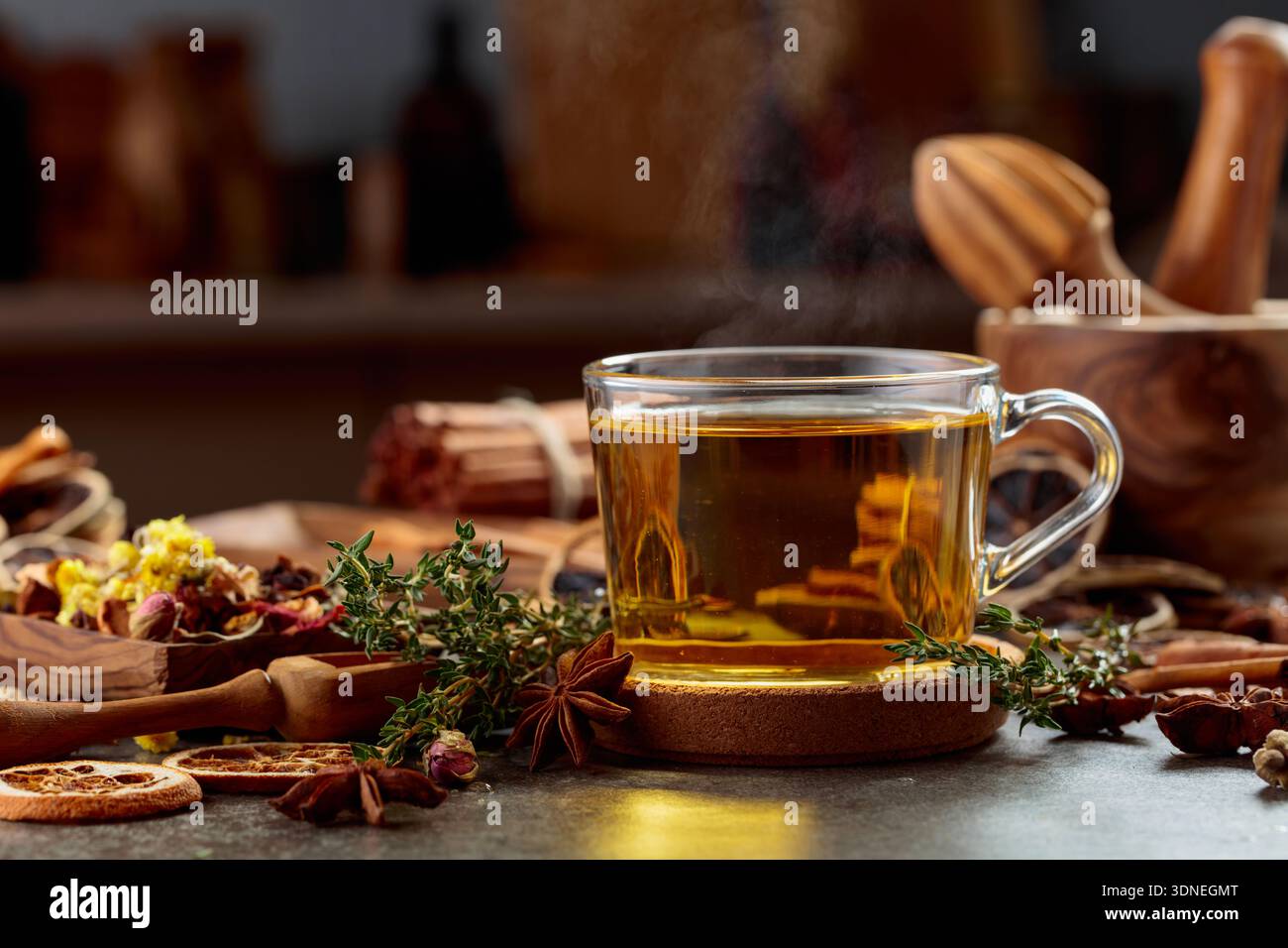 Cup of herbal tea with ingredients and spices on the kitchen table ...
