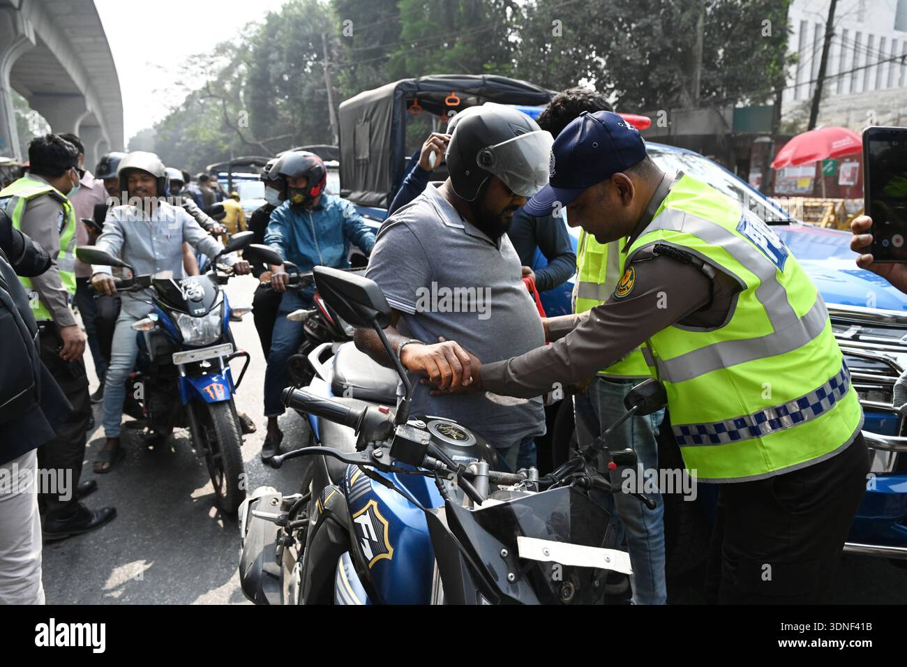 Police personnel search people and vehicle at a checkpoint ahead of the ...