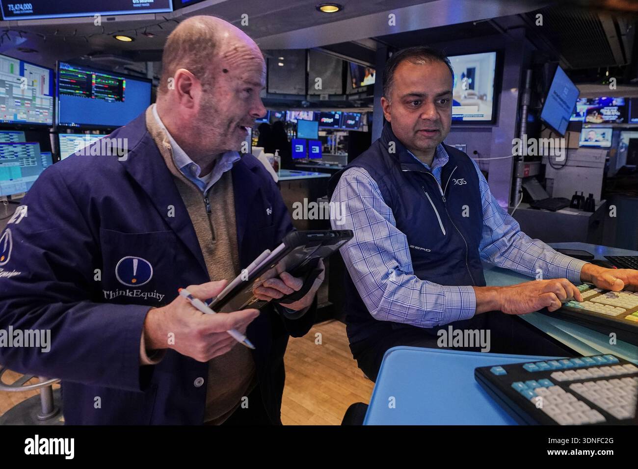 Trader Peter Mancuso, left, and specialist Dilip Patel work on the ...