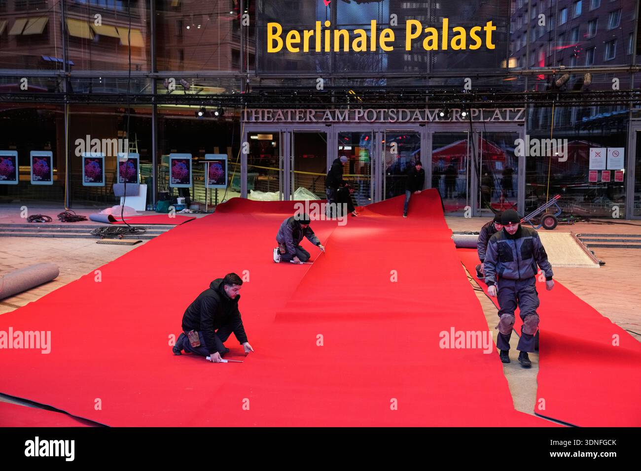 Workers roll out the red carpet ahead of the 76th Berlinale ...
