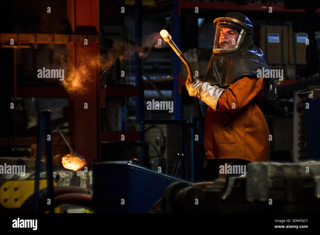 A Furnace man tests molten metal as part of the process to create BAFTA ...