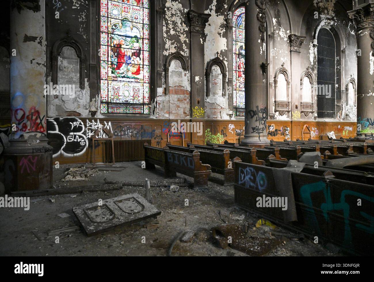 Broken pews, graffiti and debris are seen inside Saint-Eusebe-de ...