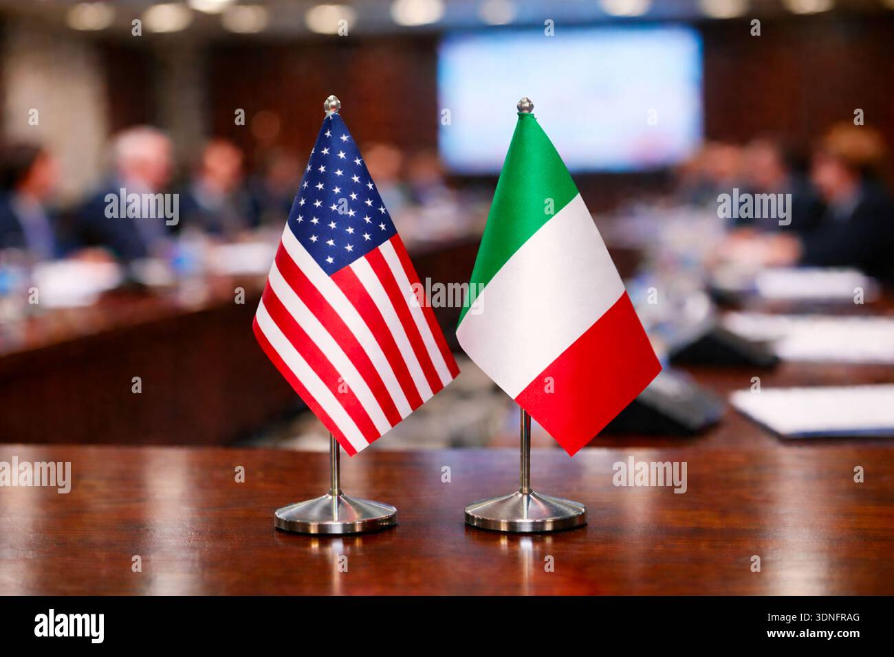 Two small national flags of United States and Italy placed on a ...