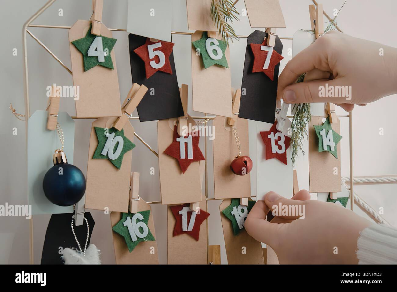A person's hand opening a customizable Christmas advent calendar with ...
