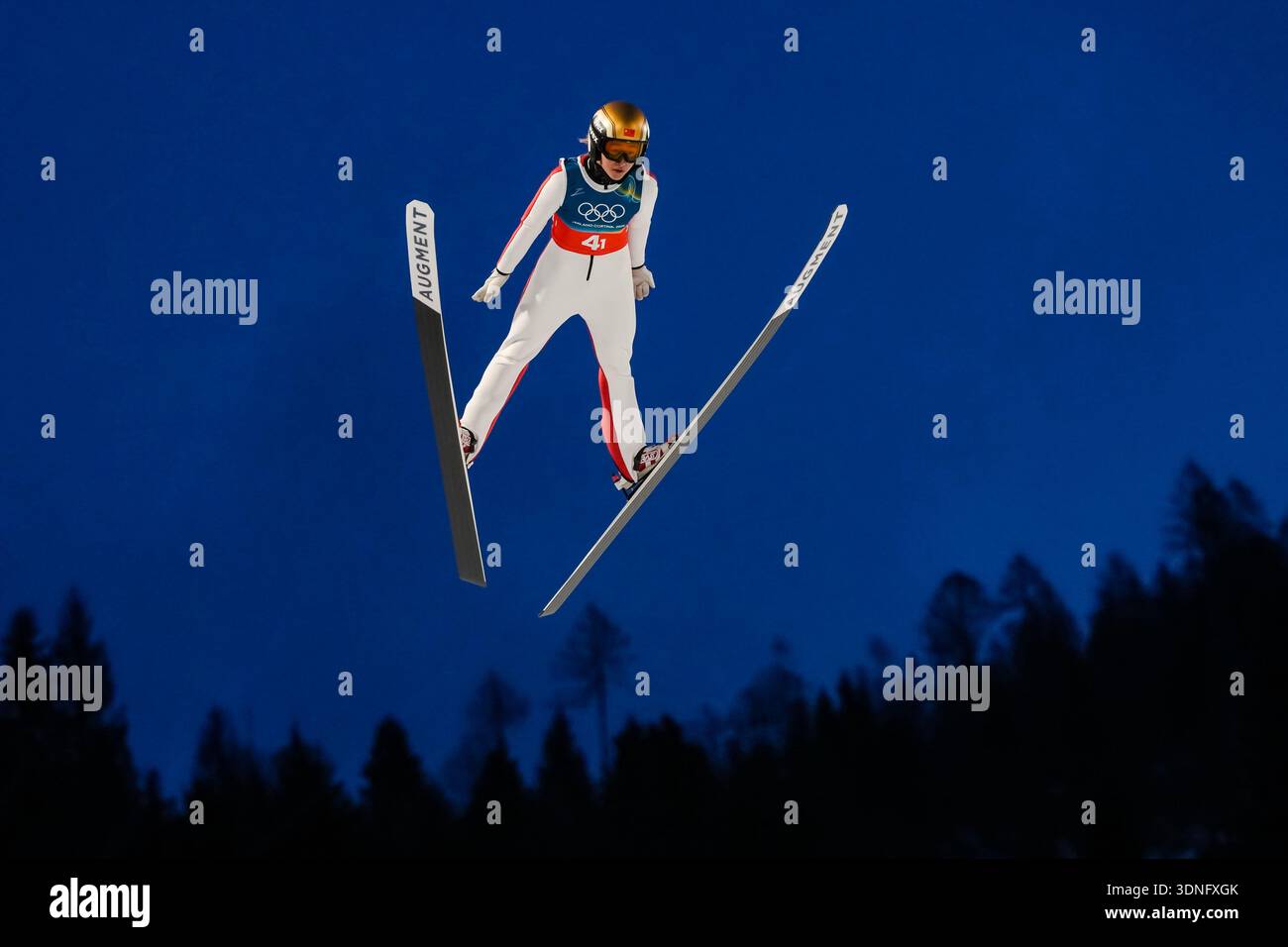Zeng Ping, of China, soars through the air during the ski jumping mixed ...