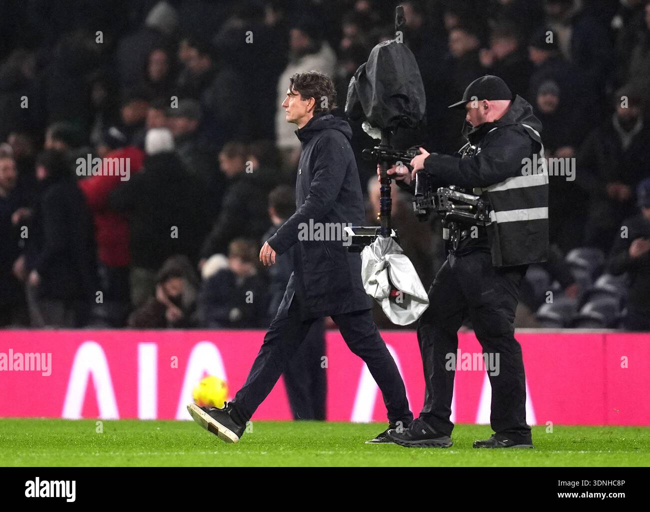 Tottenham Hotspur manager Thomas Frank (left) walks onto the field ...