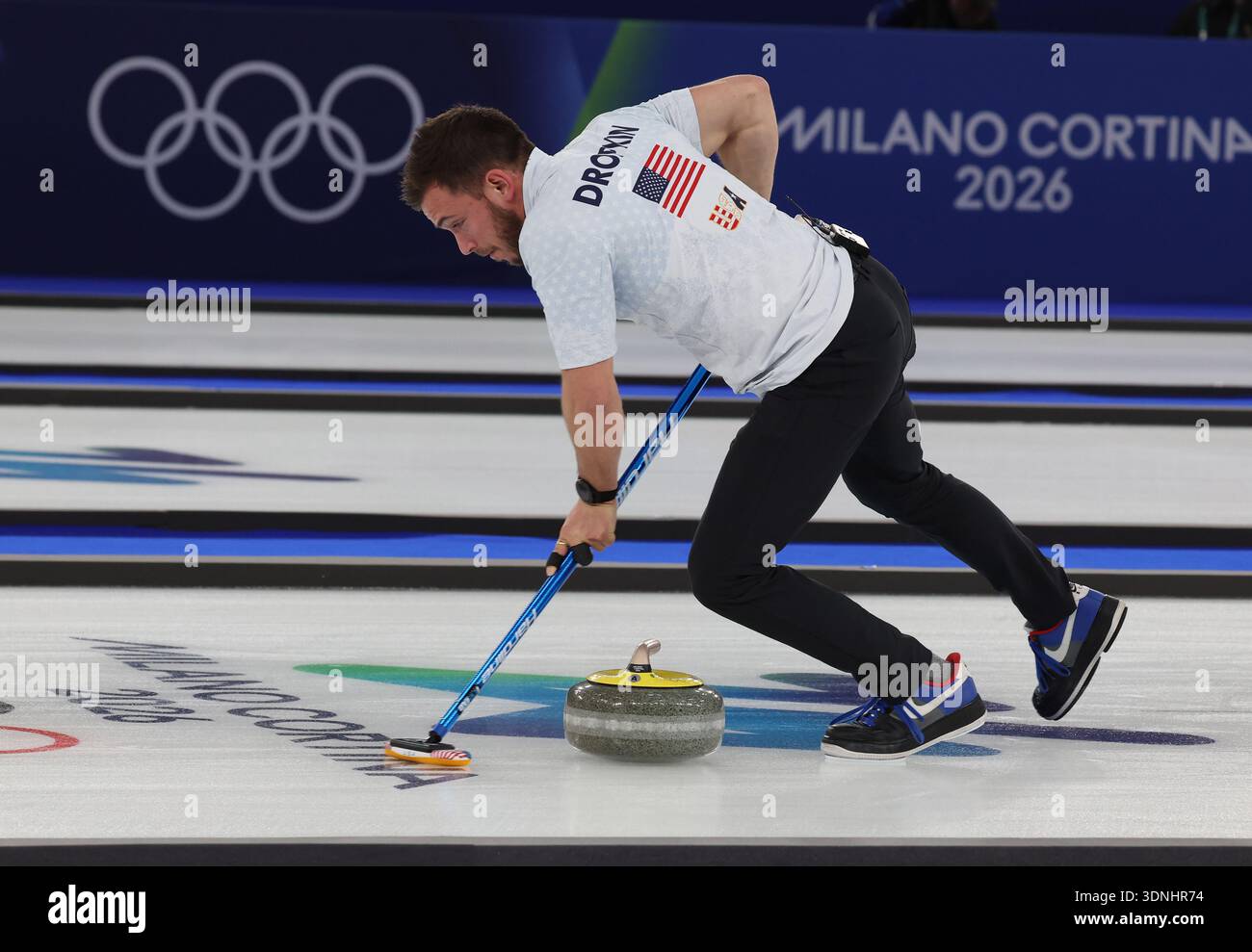 Team USA's Korey Dropkin polishes the ice for team mate Cory Thiesse ...