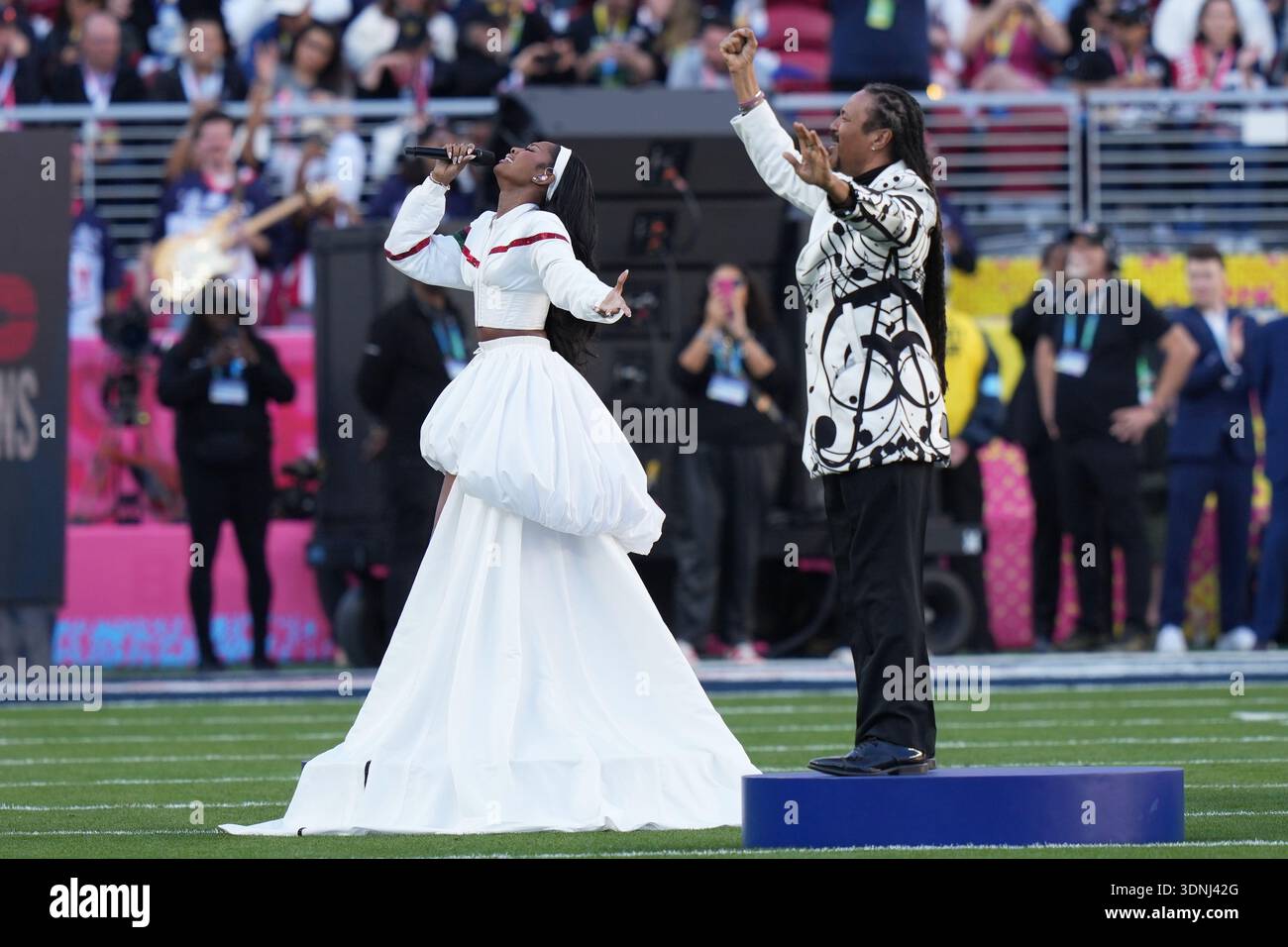 Coco Jones, left, performs before the NFL Super Bowl 60 football game ...