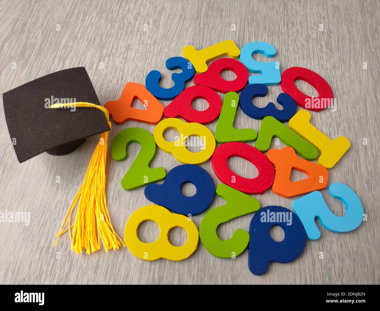 Colorful number blocks and a miniature graduation cap, symbolizing ...