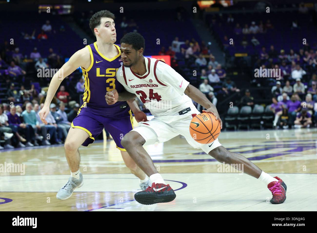 Arkansas forward Nick Pringle (23) tries to drive past LSU guard Max ...