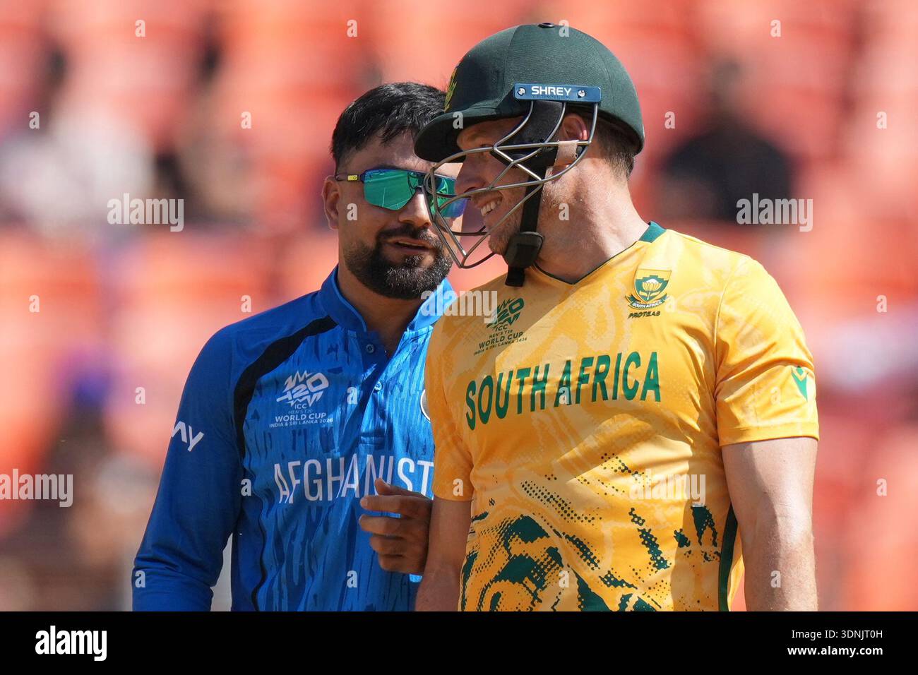 Afghanistan's captain Rashid Khan, left shares a light moment with ...