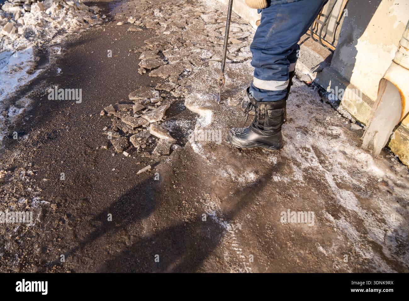 Street cleaner breaking ice with breaker tool, cleaning iced formation ...