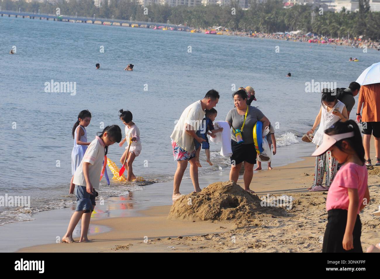 Tourists enjoy vacation on beach at Sanya Bay scenic area in Sanya City ...
