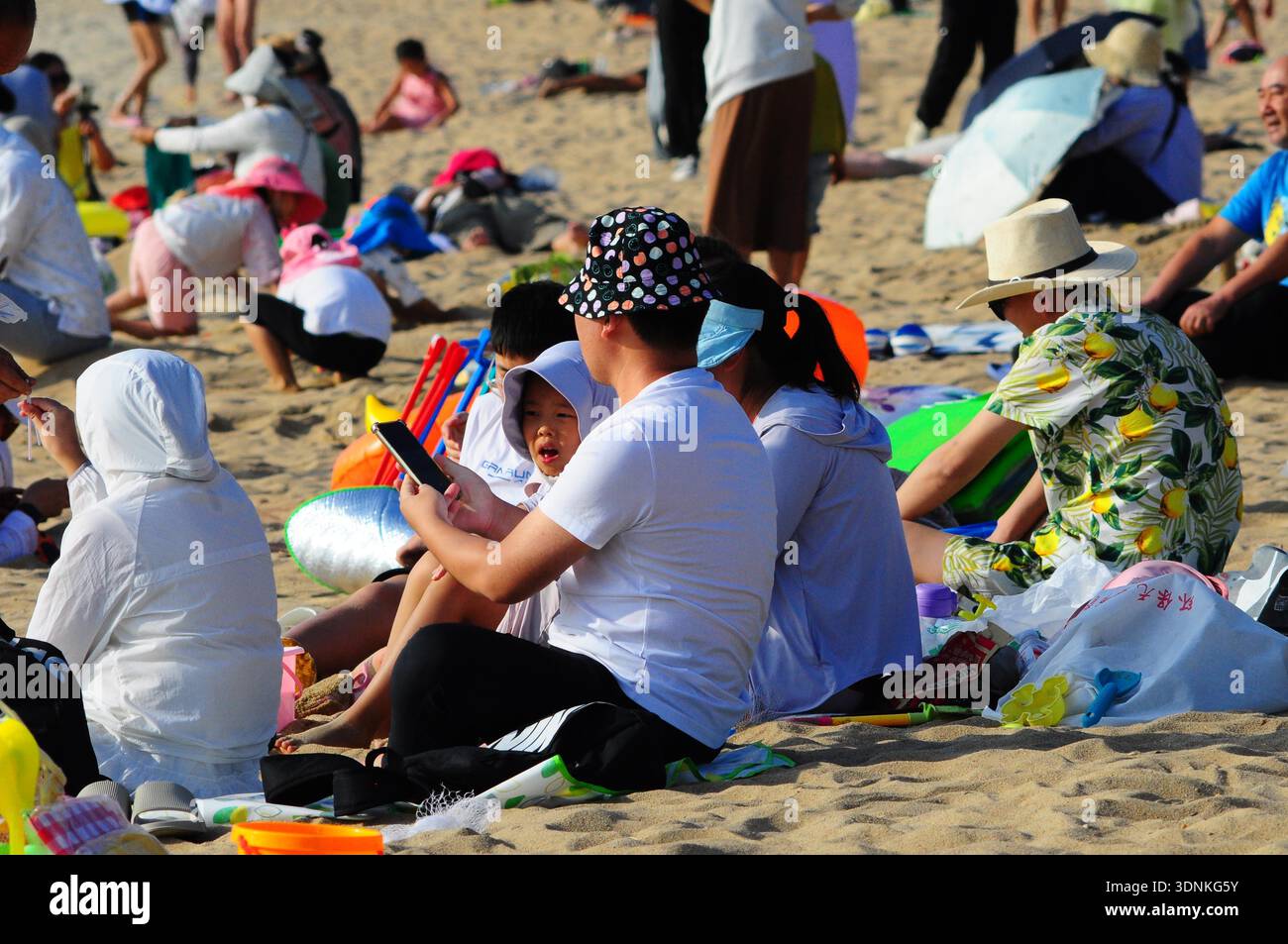 Tourists enjoy vacation on beach at Sanya Bay scenic area in Sanya City ...