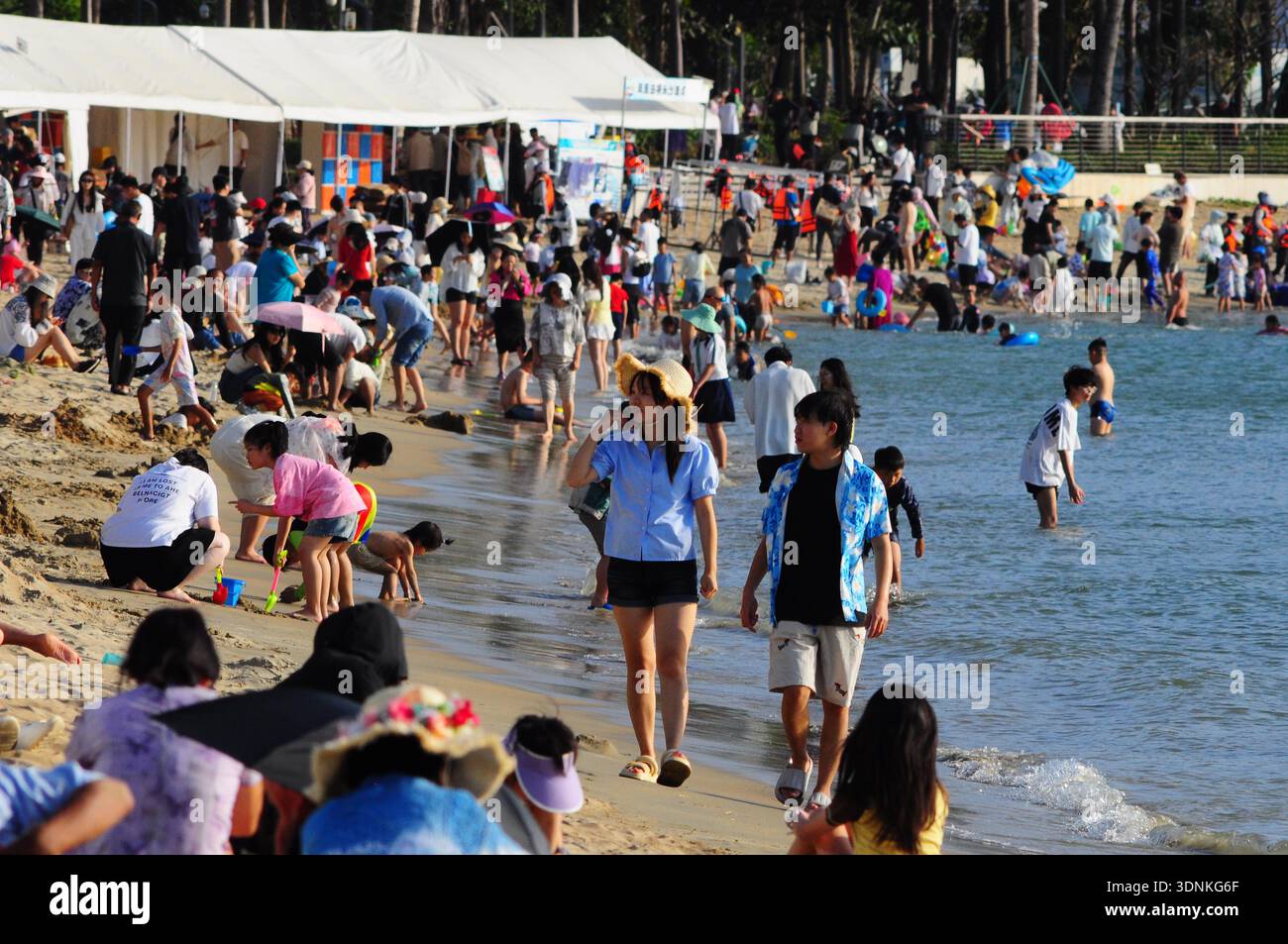 Tourists enjoy vacation on beach at Sanya Bay scenic area in Sanya City ...