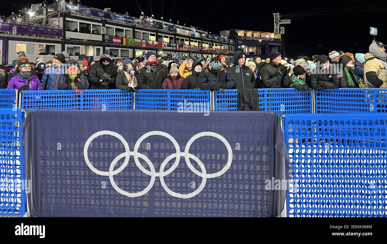 Livigno, Italy - February 9, 2026: Spectators gathered behind barriers ...