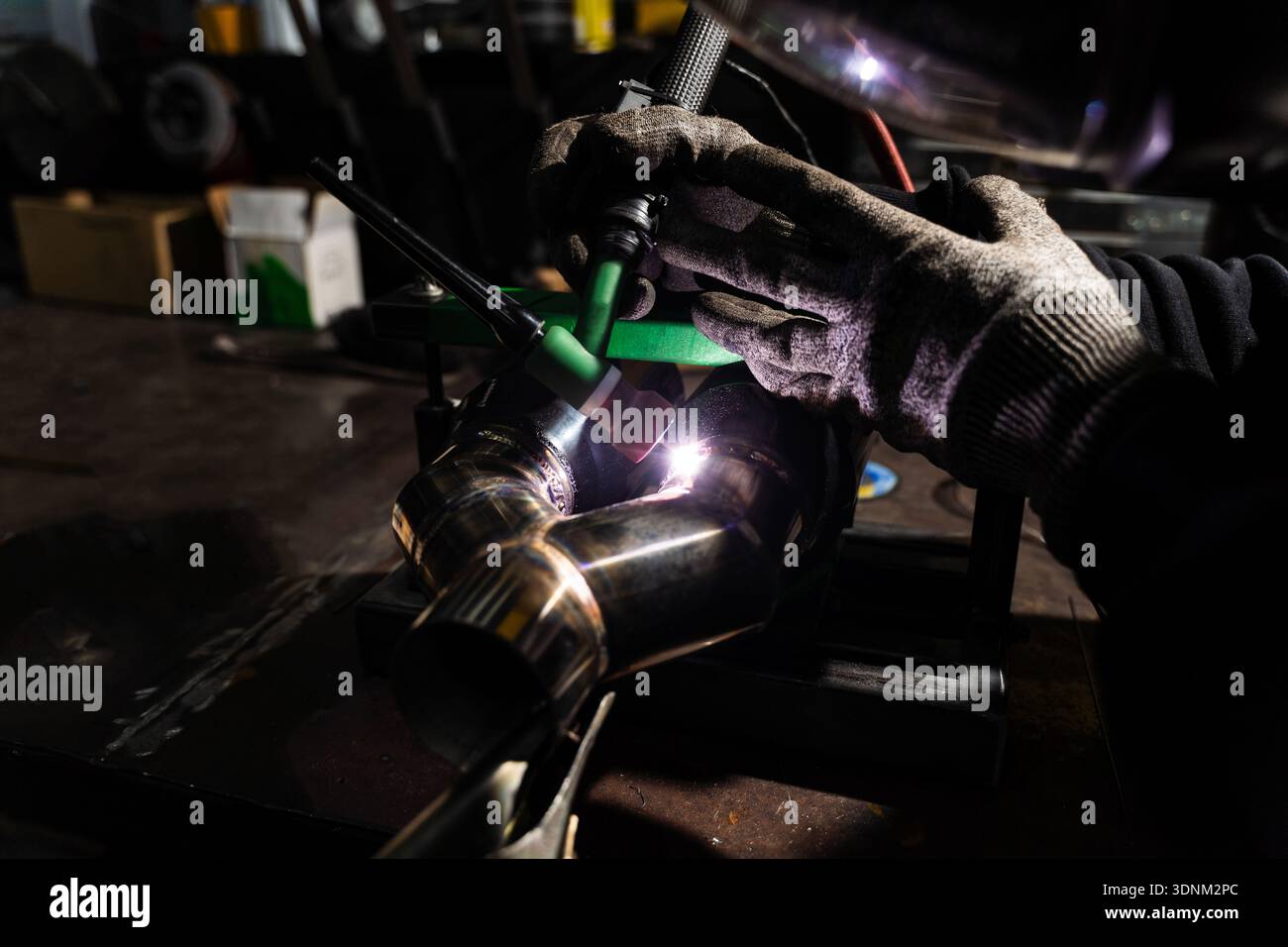 Auto mechanic welding custom exhaust pipe with tungsten inert gas Stock ...