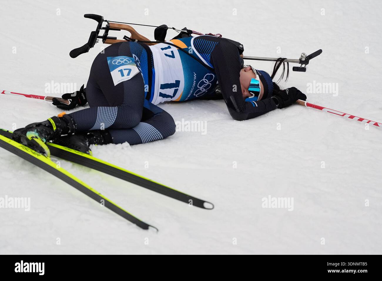 Tuuli Tomingas, of Estonia, collapses after crossing the finish line of ...