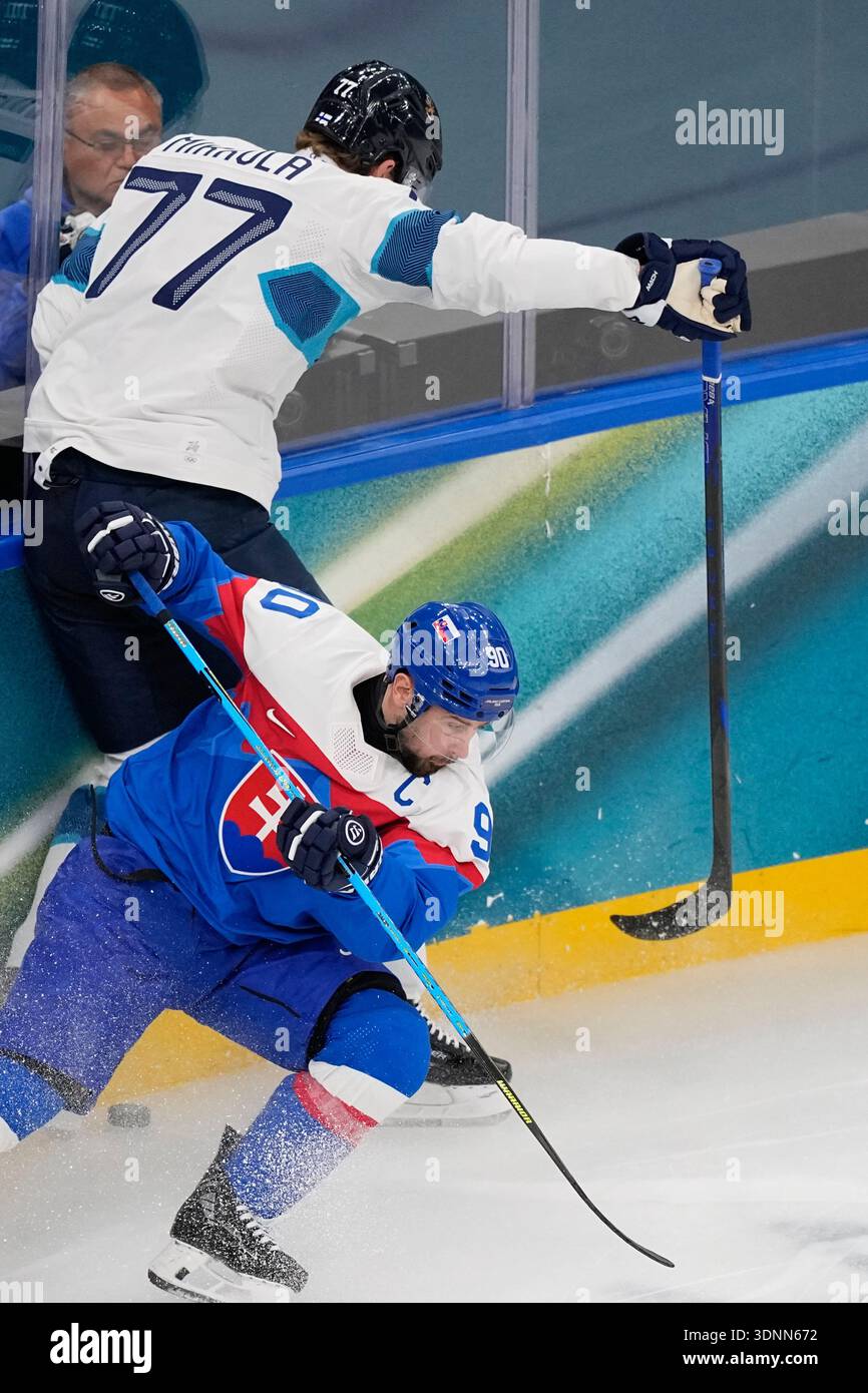 Finland's Niko Mikkola (77), top, challenges Slovakia's Tomas Tatar (90 ...