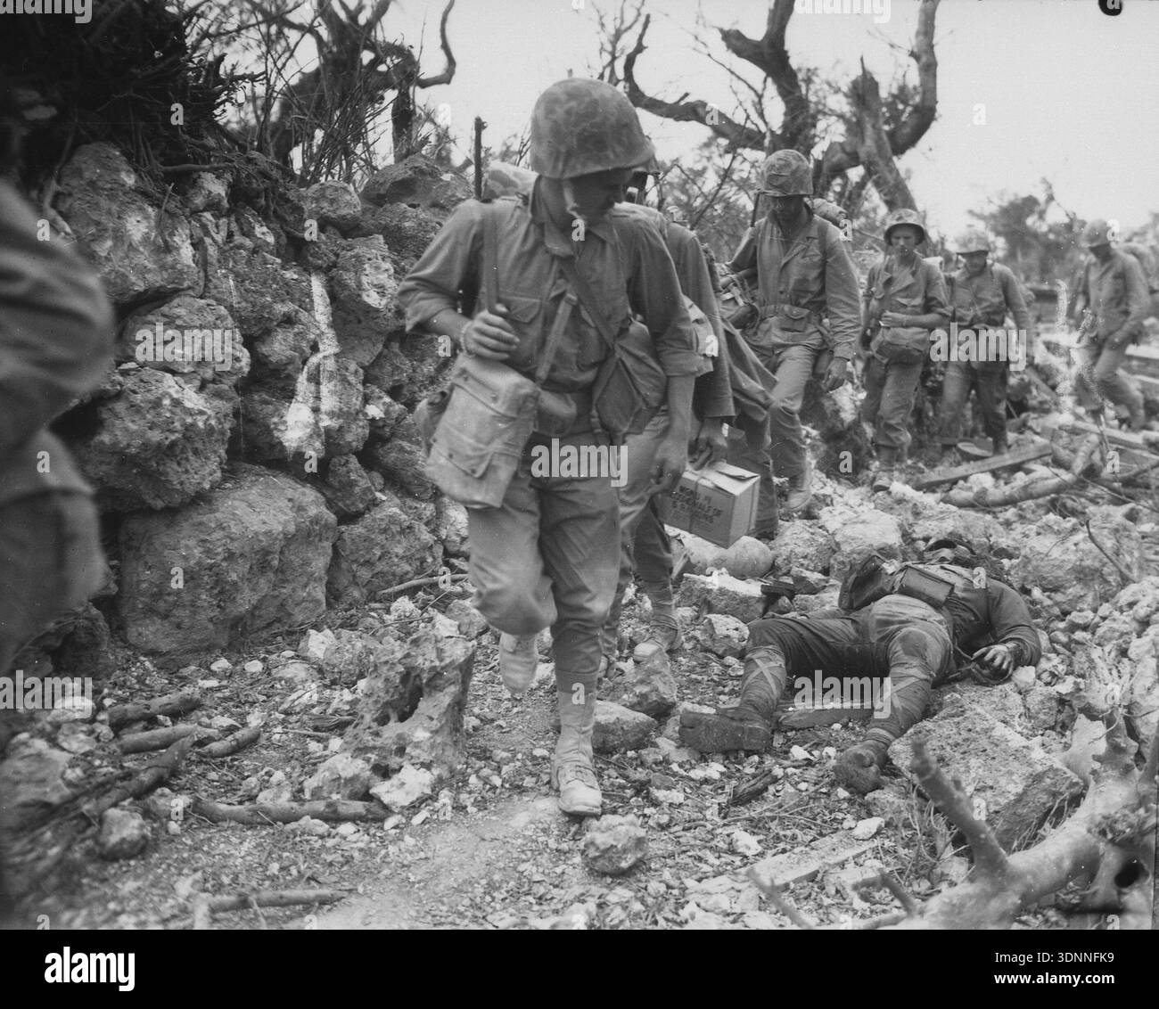 American Marines pass through a small village where Japanese soldiers ...