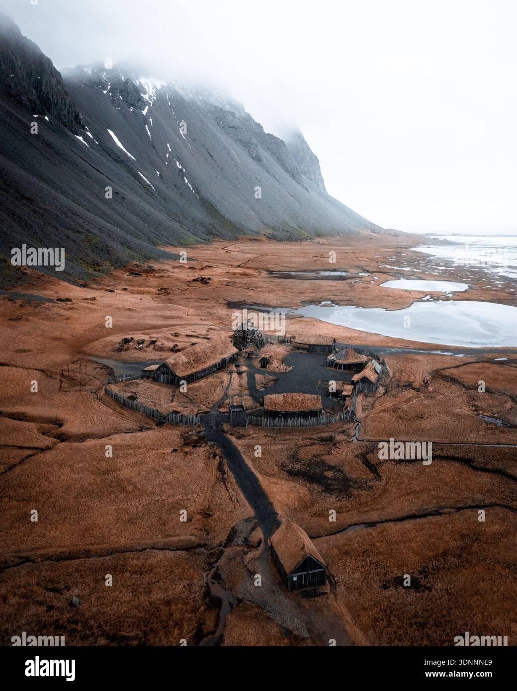 Aerial view of a cinematic landscape where a historic Viking village ...