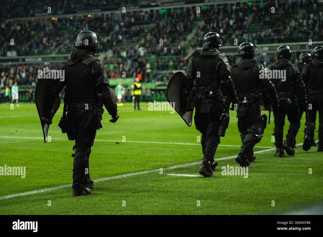 Security guards armed with shields on the football pitch during a ...
