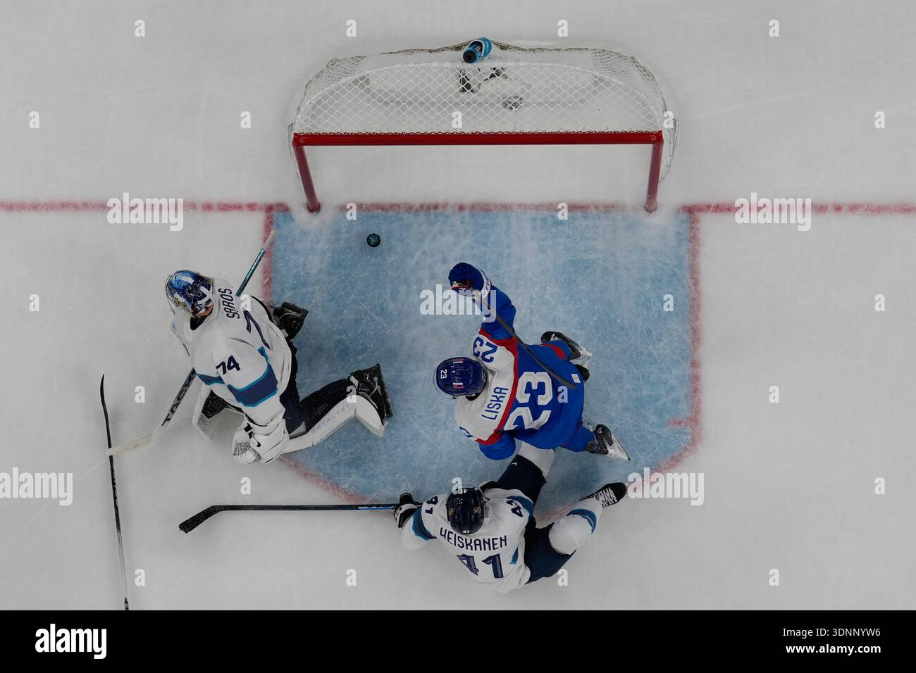 A puck shot by Slovakia's Dalibor Dvorsky goes past Finland's ...