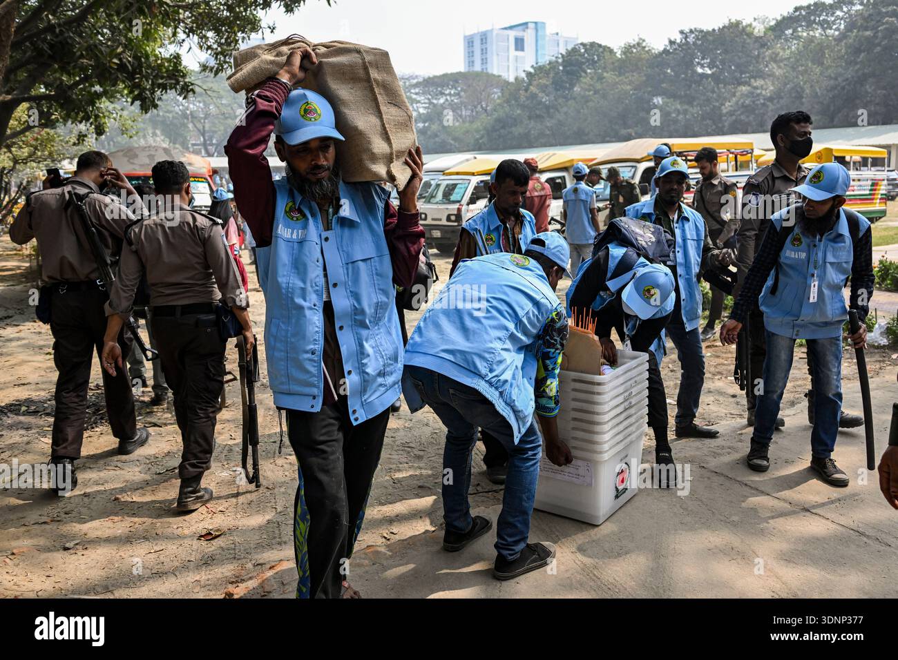 A law enforcement officer seen carrying ballot boxes and other election ...