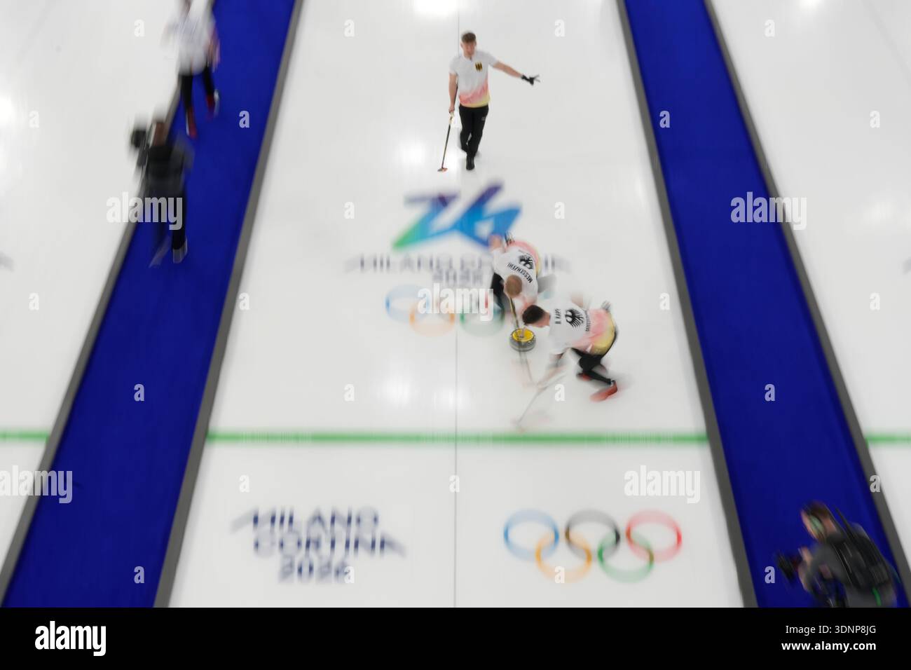 Germany's Benjamin Kapp and Feliz Messenzehl sweep a stone during a men ...