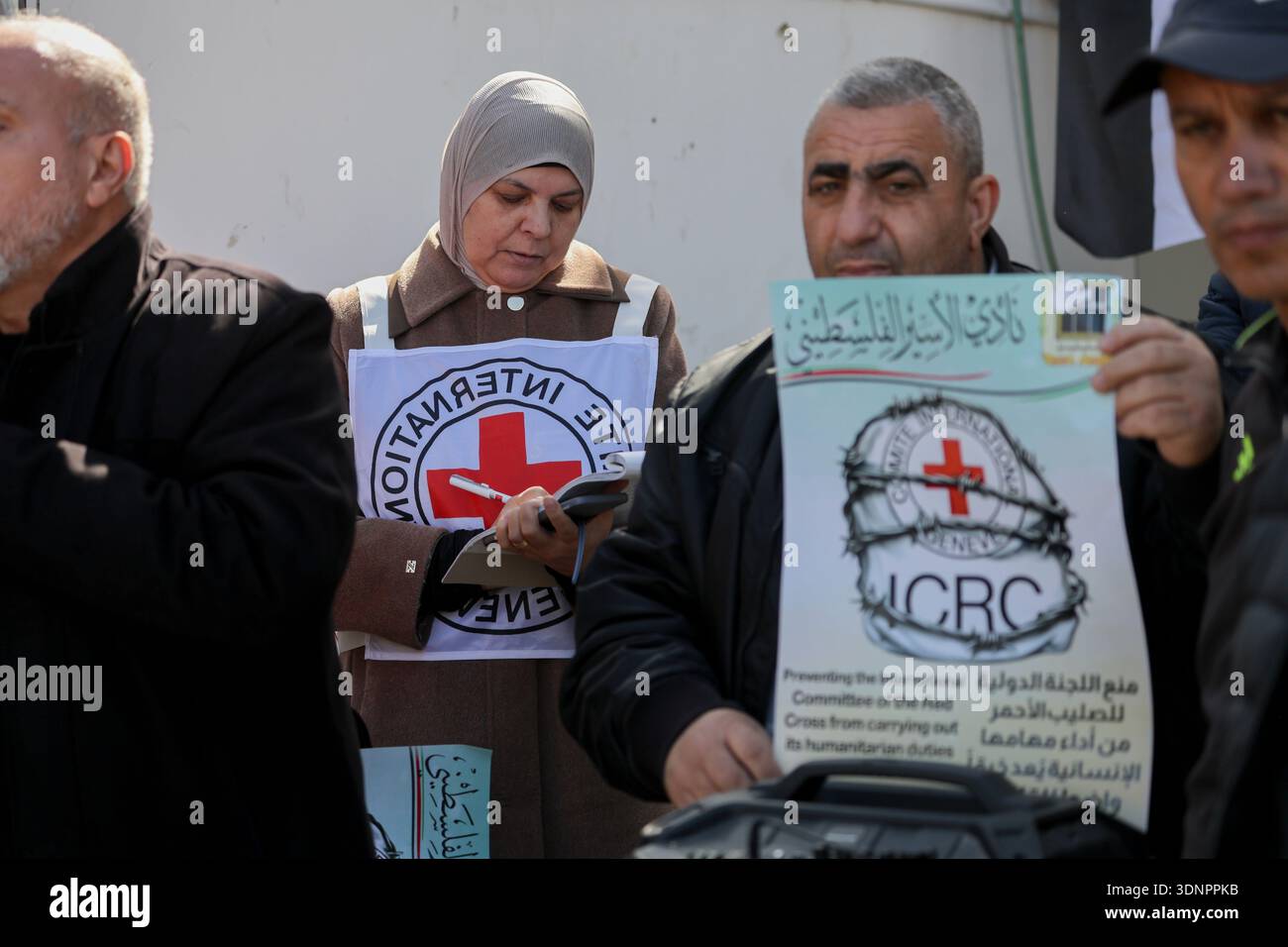 Protesters hold posters bearing the logo of the International Committee ...