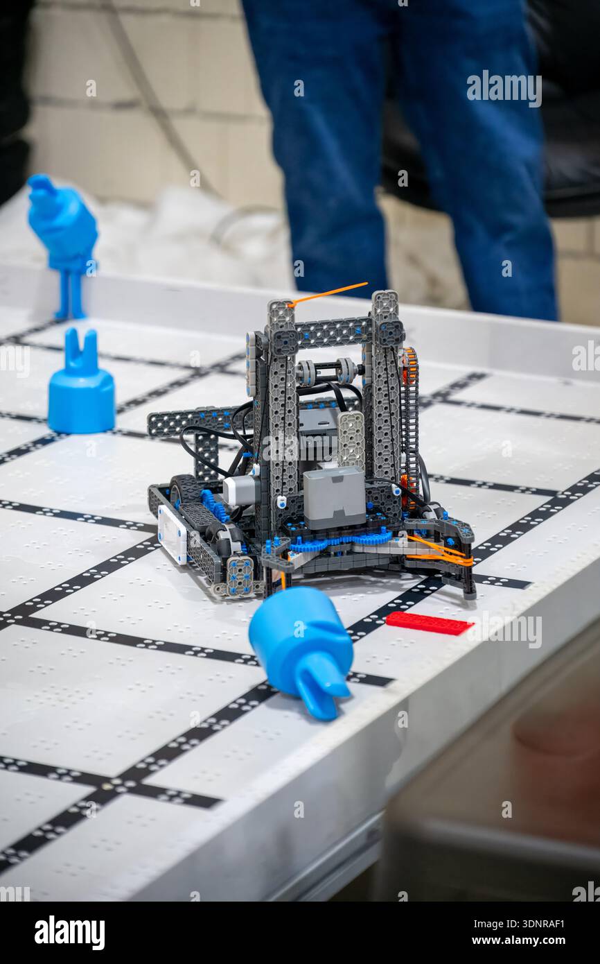 Students build and program a robot to navigate an obstacle course in a ...