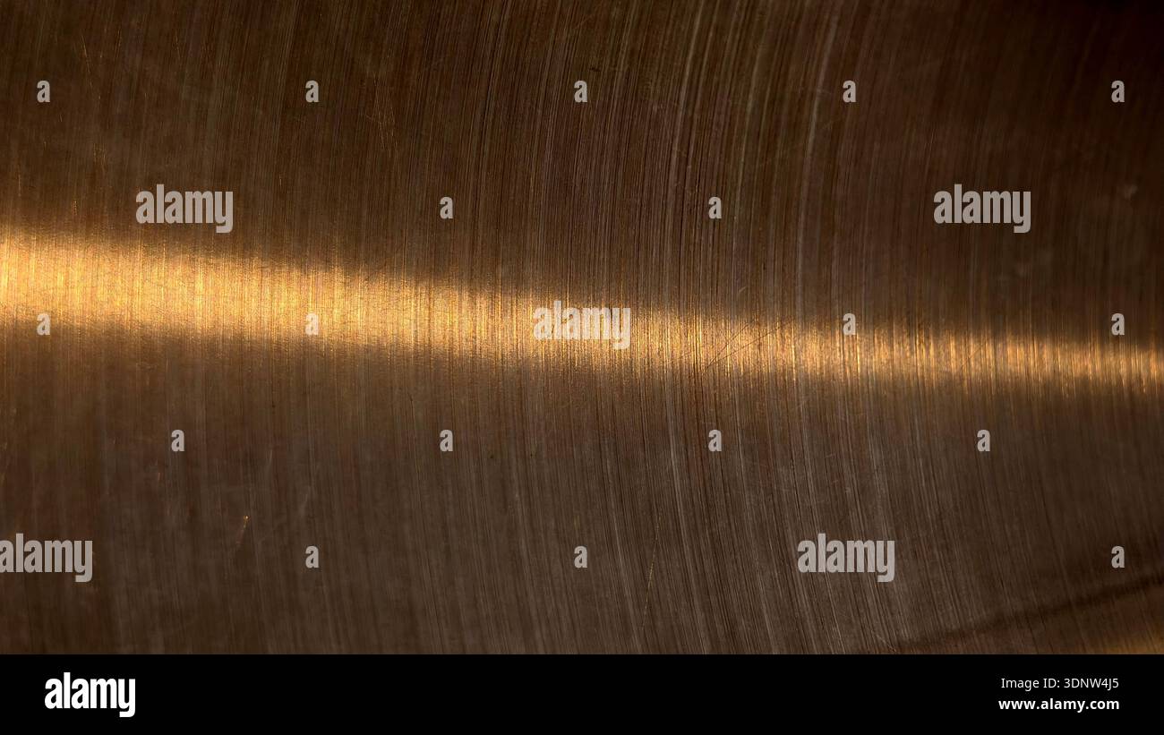 Brushed dark bronze metal texture with light reflection. This warm ...