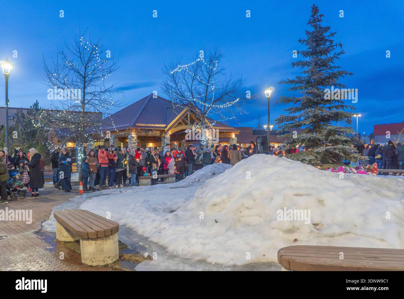 People attend a vigil to honour the victims of a mass shooting in ...