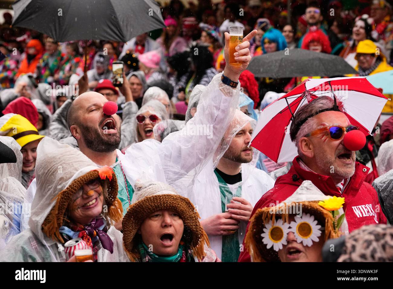 Revellers celebrate the start of the street carnival in the pouring ...