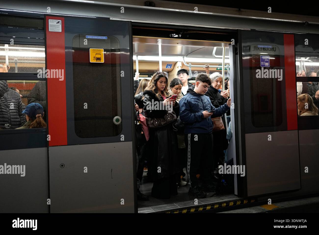 People take the metro in Milan, Italy, Monday, Feb. 9, 2026. (AP Photo ...
