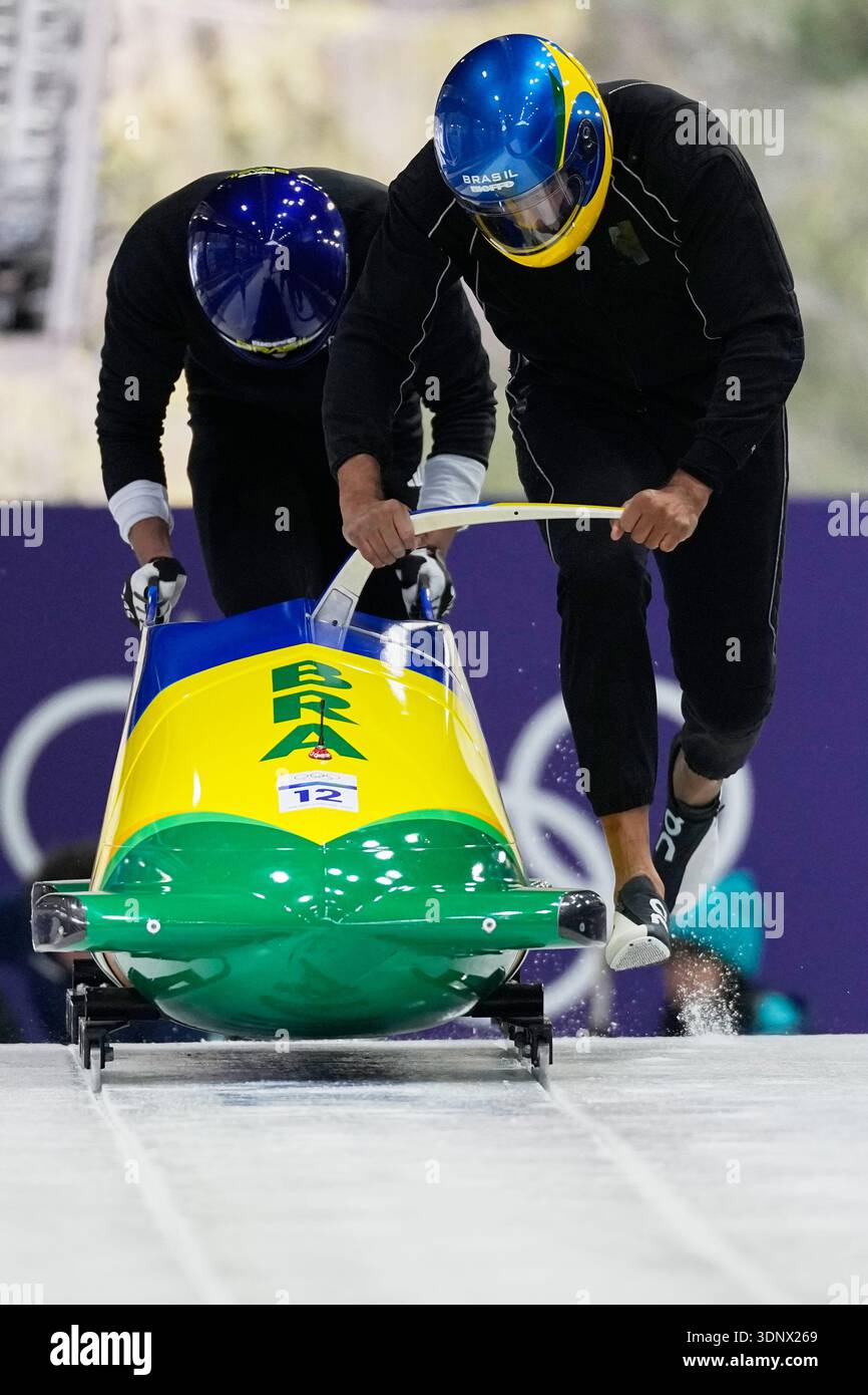 Brazil's Edson Luques Bindilatti, right, starts for a two man bobsled ...