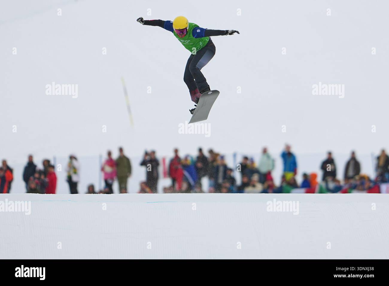 Austria's Jakob Dusek (9) competes during the men's snowboard cross ...