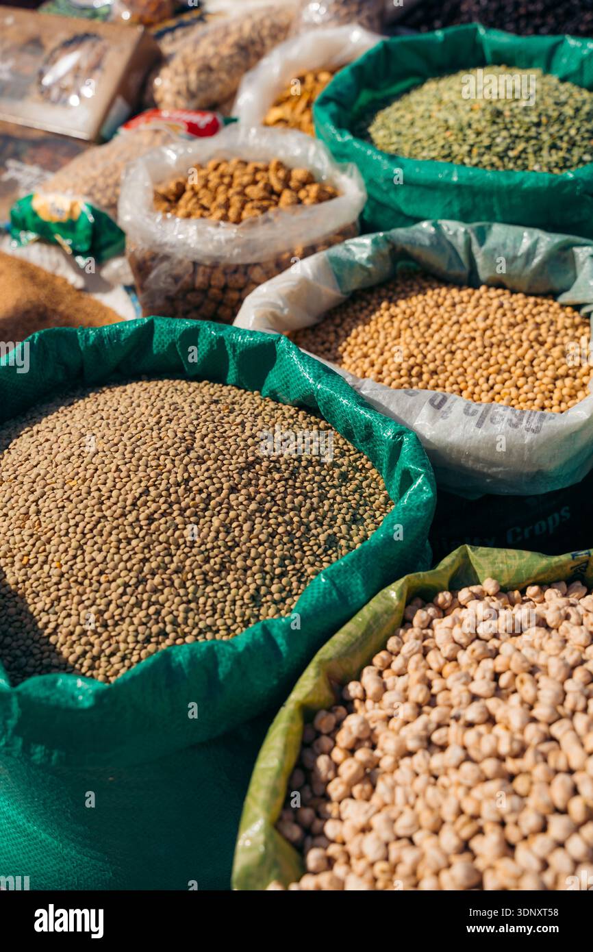 A colorful assortment of grains and legumes in large sacks at a ...