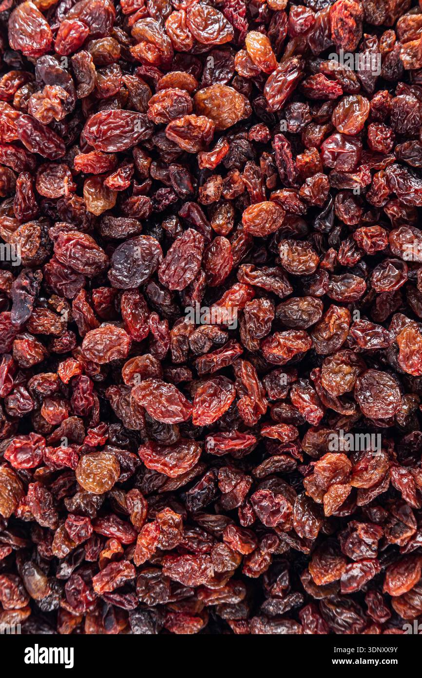 Top view of dried raisins in rich brown hues. The glossy, wrinkled ...