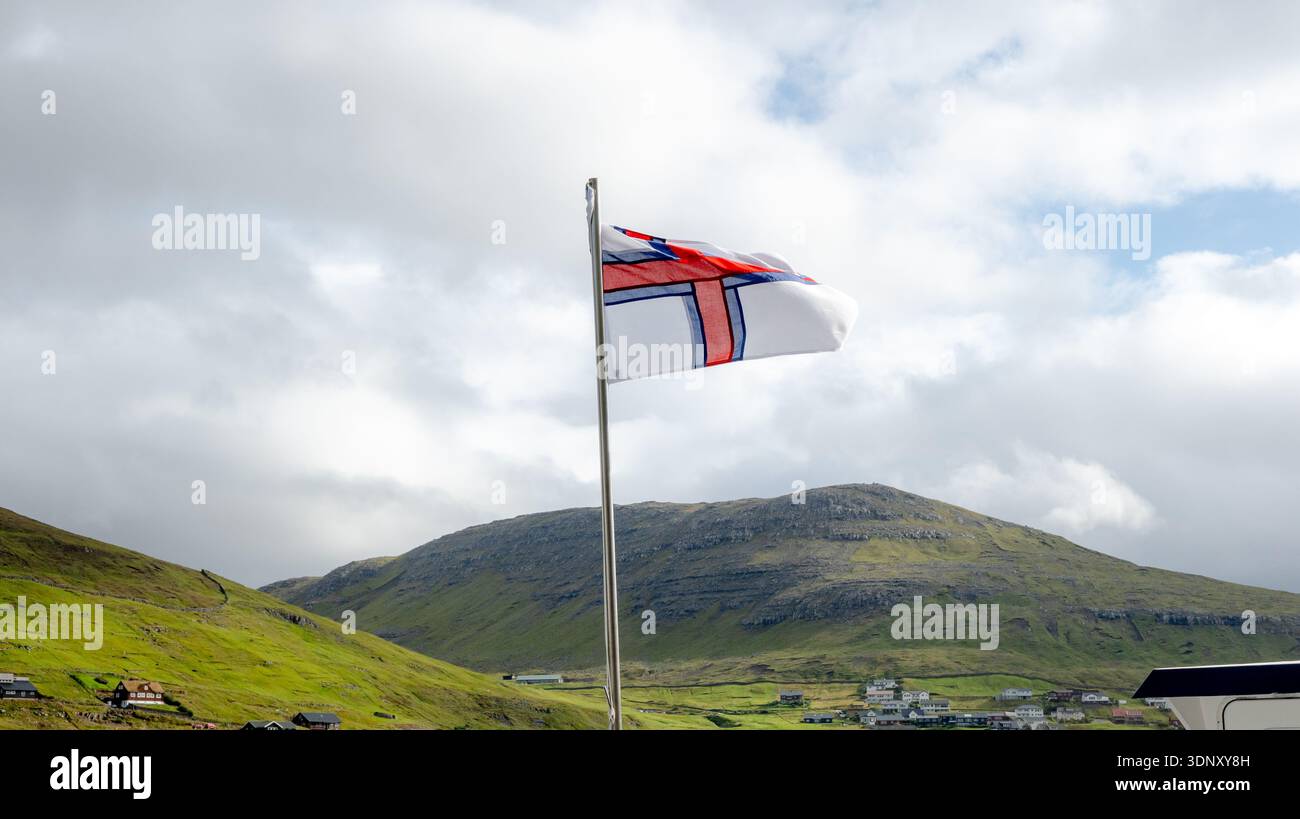 Majestic view of the Faroe Islands flag fluttering against the backdrop ...