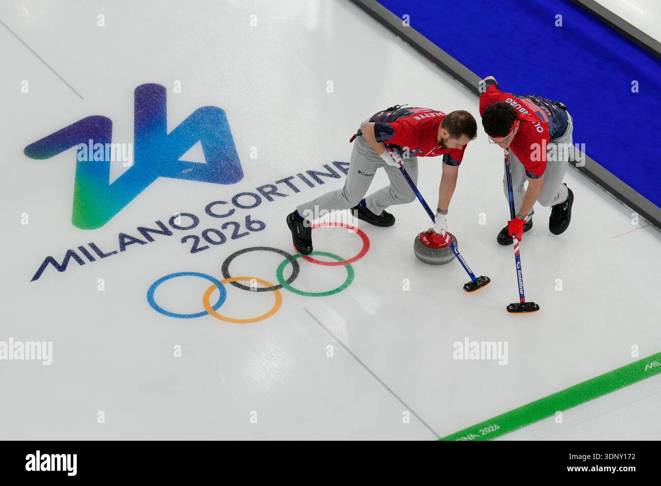 United States' Luc Violette and Aidan Oldenburg sweep ahead of a stone ...