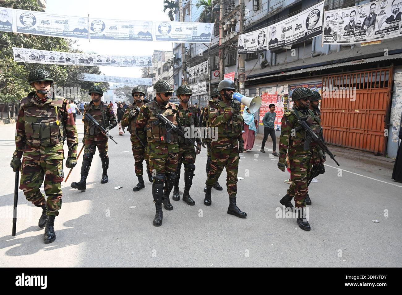 Bangladesh Army personnel patrol along a street outside a polling ...