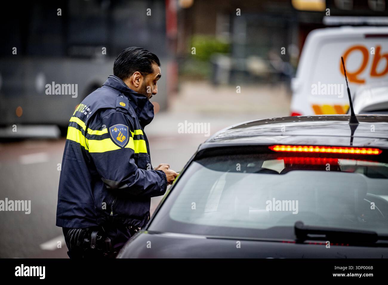 GOUDA - A police officer is checking ROBIN UTRECHT /ANP netherlands out ...