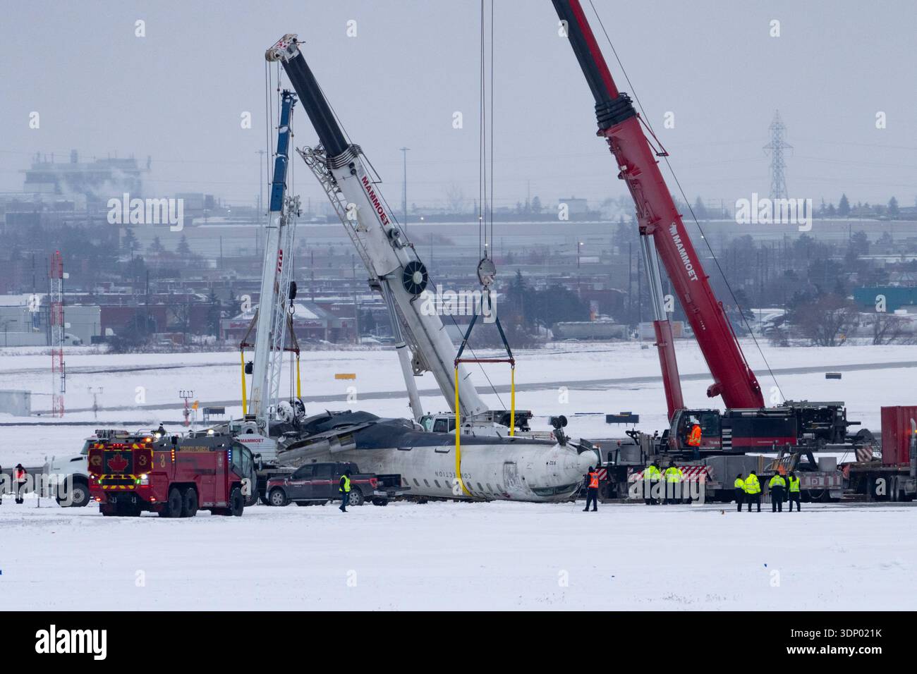 Cranes are positioned to remove the wreckage of Delta Flight 4819 from ...