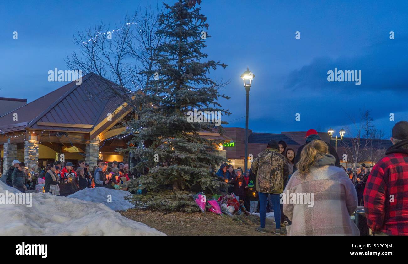 People attend a vigil to honour the victims of a mass shooting in ...