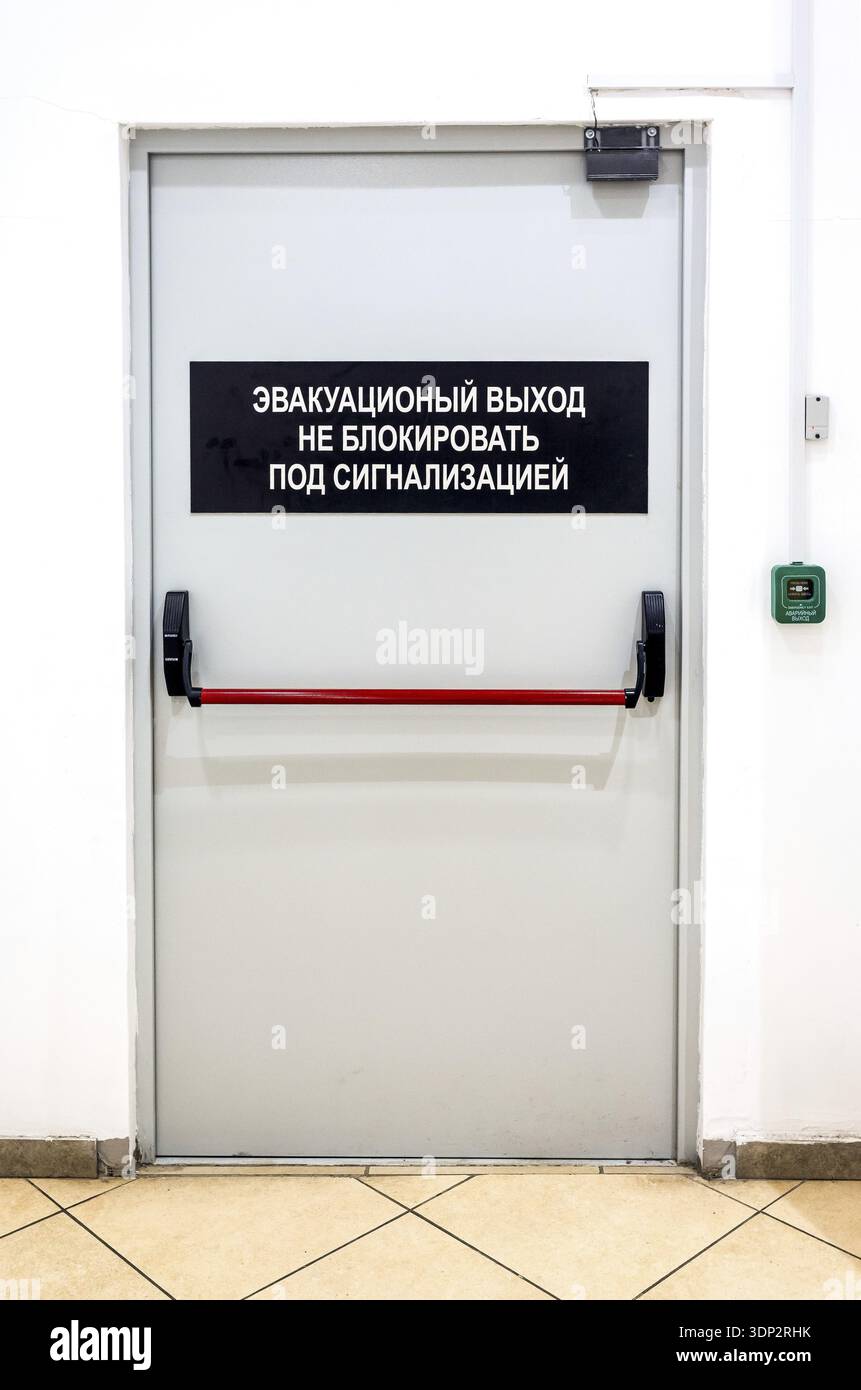 Emergency exit at city mall. Text in russian: Evacuation exit, do not ...