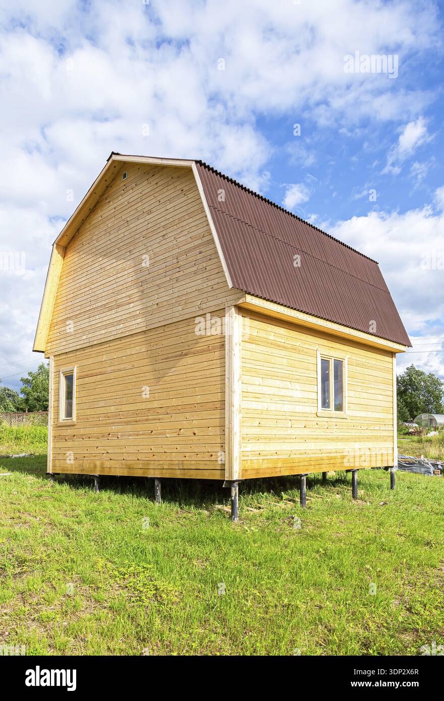 New small wooden house under construction on a metal pile foundation ...