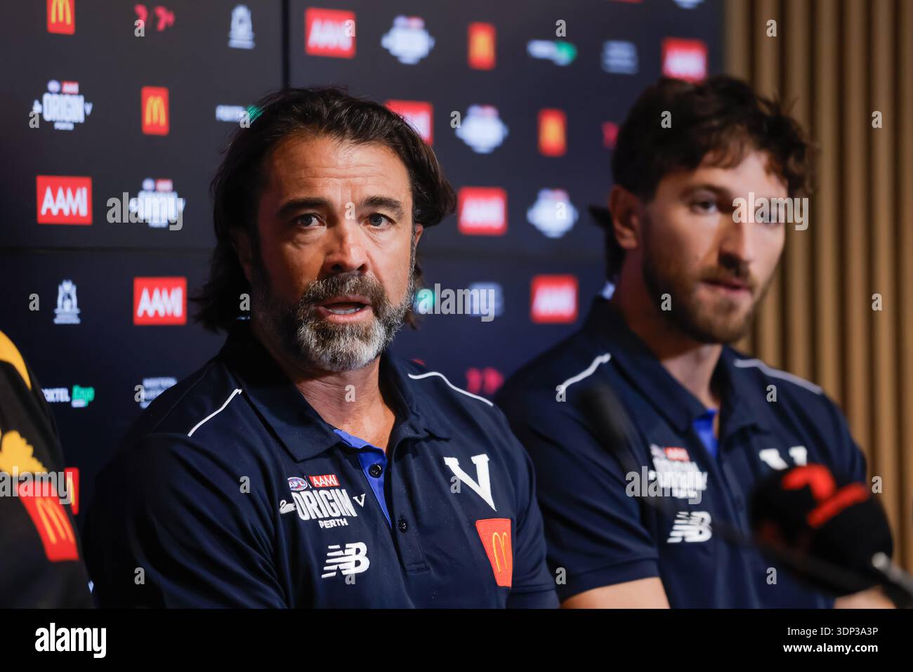 Victoria coach Chris Scott speaks captain Patrick Cripps looks on ...
