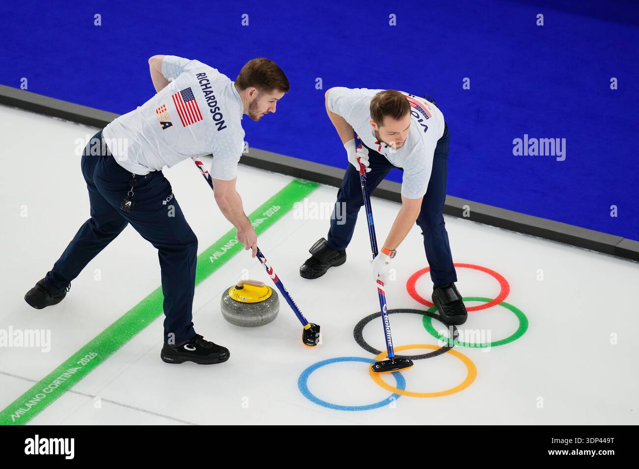 United States' Ben Richardson and Luc Violette sweep ahead of a stone ...